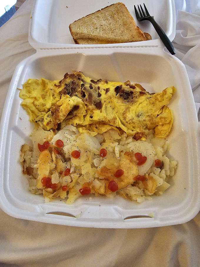 Breakfast architecture at its finest&mdash;a golden omelet that's seen more fillings than a dentist's office, paired with home fries that demand attention.