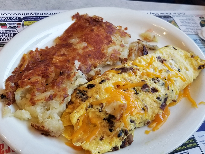 Behold the omelet in its natural habitat&mdash;fluffy, cheese-laden, and perfectly paired with home fries that deserve their own fan club.