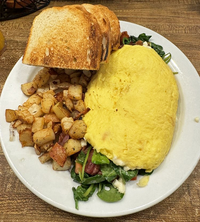 This isn't just an omelet &ndash; it's a fluffy yellow masterpiece surrounded by perfectly seasoned potatoes and toast that's achieved that elusive golden-brown perfection.