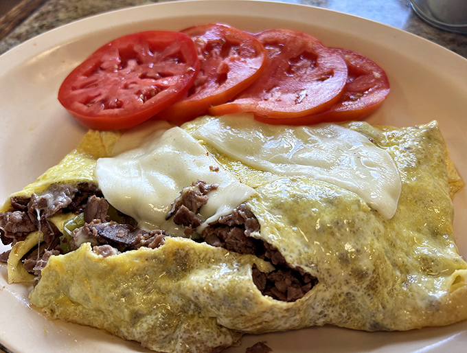 This isn't just an omelet&mdash;it's a masterclass in egg architecture, with perfectly melted cheese cascading over seasoned steak.