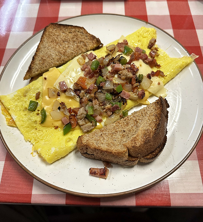 Cheese-draped perfection meets saut&eacute;ed veggies in an omelet that makes you wonder why breakfast ever has to end.