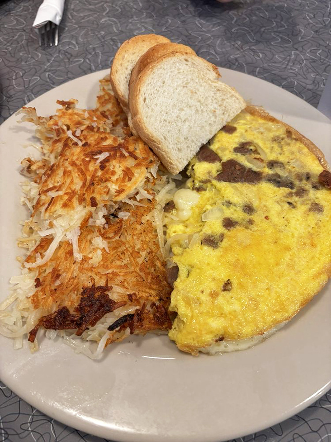 Behold the star of the show&mdash;a perfectly executed omelette with crispy hash browns that would make any breakfast aficionado weak at the knees.
