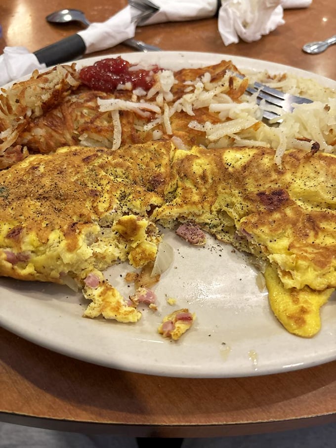 Egg architecture at its finest! This golden omelette with perfectly distributed fillings sits beside crispy home fries&mdash;a breakfast duet worth crossing the Schuylkill for.