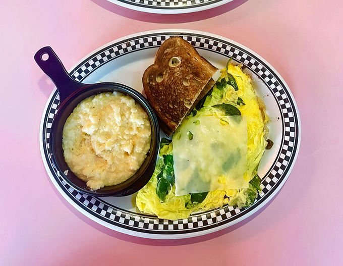 This isn't just an omelet&mdash;it's a golden envelope of possibility, stuffed with fresh vegetables and served with grits that would make any Southerner proud.