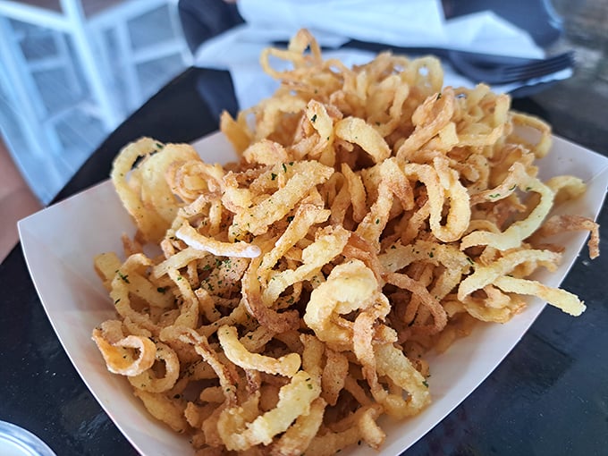 Crispy onion straws that shatter with each bite—the seafood's opening act that threatens to steal the show. Impossible to eat just one handful.