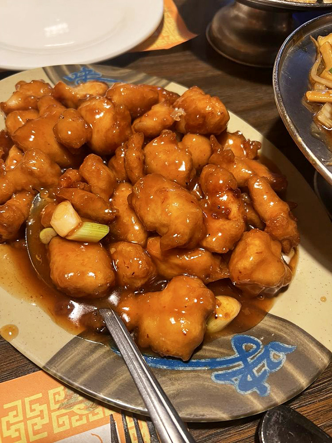 Behold, the orange chicken that launched a thousand return visits. That sauce&mdash;glossy, vibrant, studded with scallions&mdash;is what food dreams are made of.