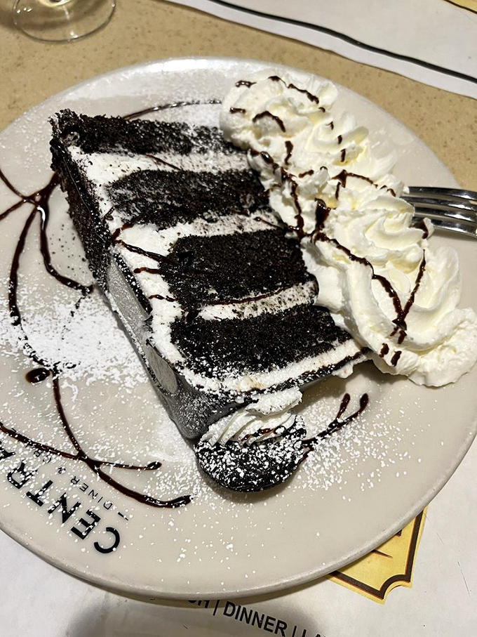 Layer upon layer of chocolate decadence with whipped cream standing by for moral support. This isn't just cake; it's therapy without the hourly rate.