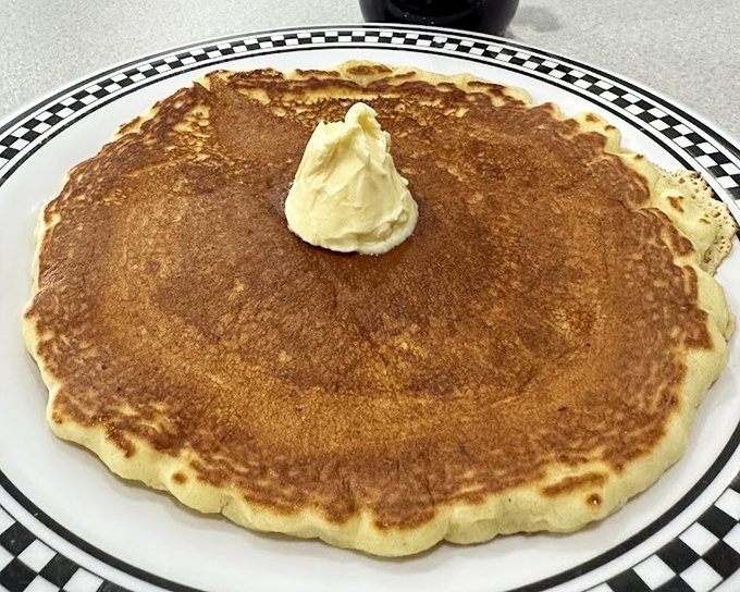 Golden perfection in circular form. This pancake's crispy edge and fluffy center create the textural paradise that keeps locals coming back.