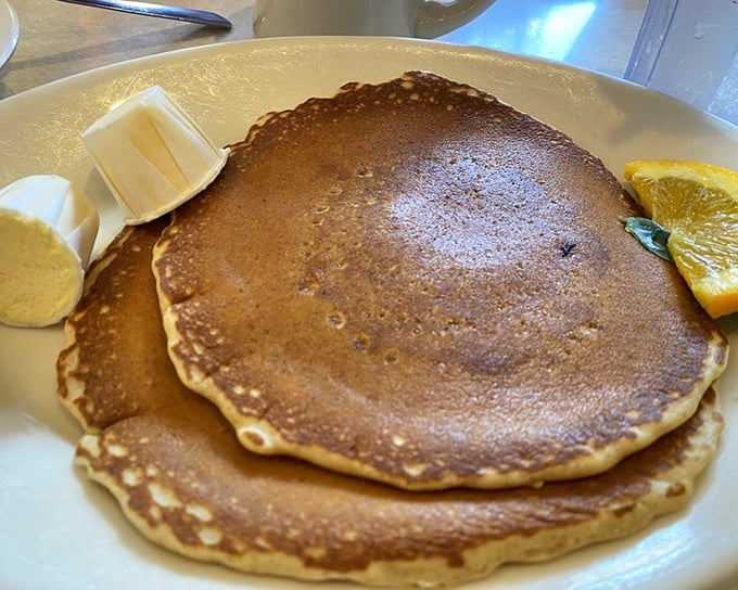 Golden-brown pancakes with a pat of butter and orange slice&mdash;simple perfection that would make Marcel Proust forget all about madeleines.