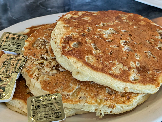 Walnut pancakes stacked higher than your weekend expectations. Each forkful is like biting into a cloud that somehow tastes like childhood.