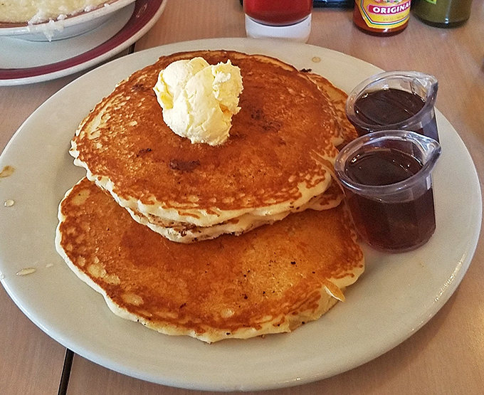 Golden pancakes that could make IHOP executives weep with envy. That pat of butter melting on top isn't just garnish &ndash; it's performance art.