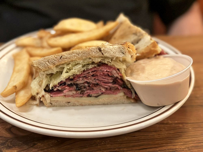 Not just a sandwich, but an engineering marvel. Layers of hand-cut pastrami creating the skyscraper of satisfaction that architects of hunger dream about.