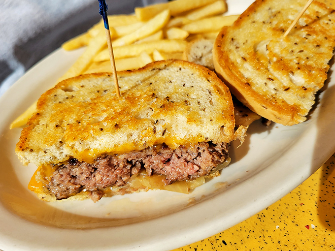 The star of the show: Noshville's patty melt in all its grilled, cheesy glory. That perfect cross-section reveals the holy trinity of beef, cheese, and caramelized onions.