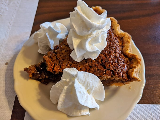 Behold the pecan pie that launched a thousand diet cheat days. Those dollops of whipped cream aren't garnish&mdash;they're essential companions on this sweet journey.