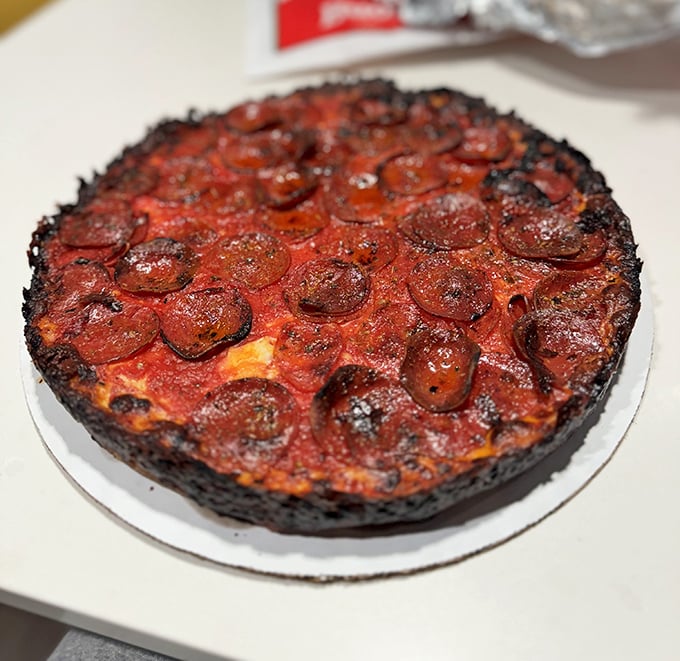 Behold pizza perfection: a blackened crust cradles molten cheese and those curled-edge pepperoni cups that collect flavor like tiny flavor hot tubs.