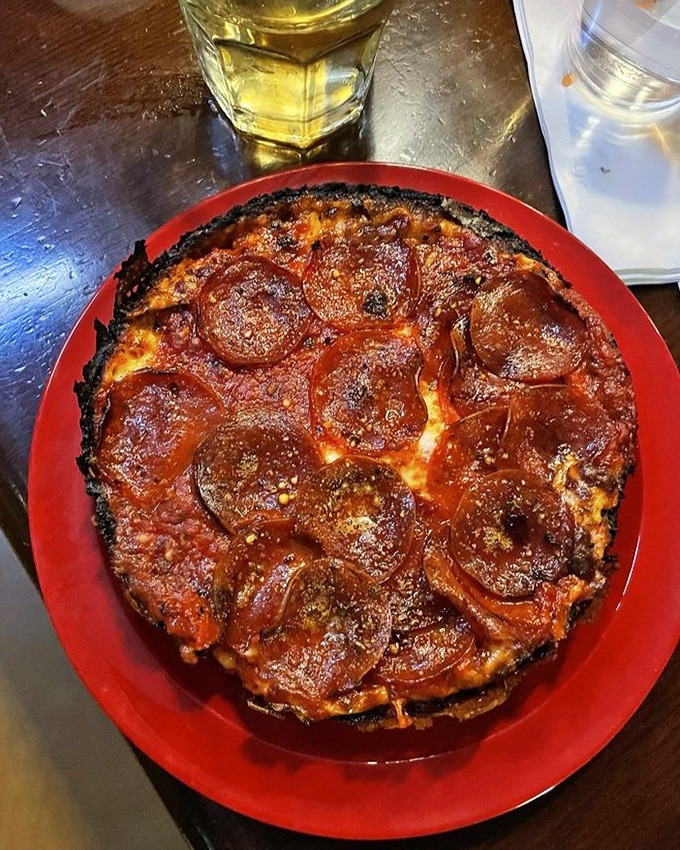 That blackened caramelized crust isn't a mistake &ndash; it's pizza nirvana. The pepperoni cups holding tiny pools of flavor are just showing off at this point.