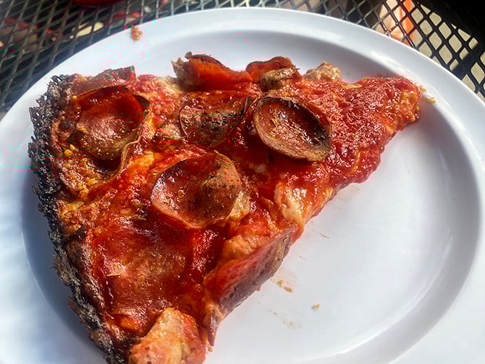 That blackened crust isn't a mistake &ndash; it's pizza nirvana. The pepperoni cups cradle tiny pools of flavor that'll haunt your dreams.