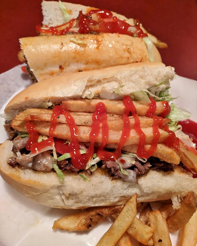 Sandwich architecture at its finest&mdash;layers of thinly sliced steak, melted cheese, and fresh toppings create a masterpiece that demands both hands and zero shame.