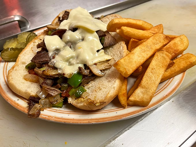 Behold the star attraction: a Philly cheesesteak that would make Philadelphians question their geography. Those golden fries aren't just sides&mdash;they're supporting actors deserving their own award.