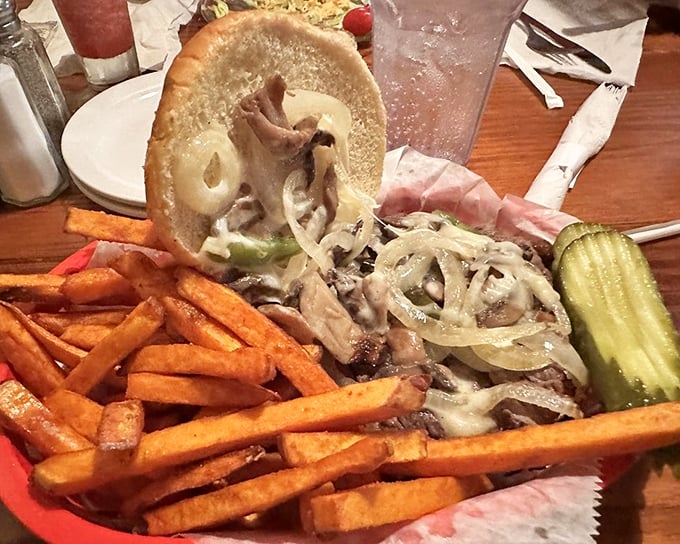 This isn't just a sandwich; it's an engineering marvel of beef, cheese, and onions that requires both hands and possibly a bib.