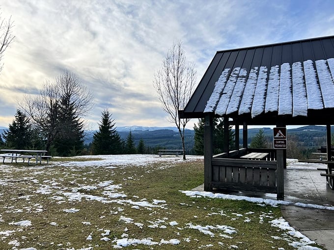Winter transforms the hilltop viewpoint into a snow-dusted postcard. The covered shelter says, "Yes, we know it rains in Oregon."