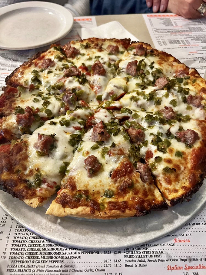 This isn't just pizza&mdash;it's edible artwork. Sausage and peppers scattered across melted cheese like confetti at the world's most delicious parade.