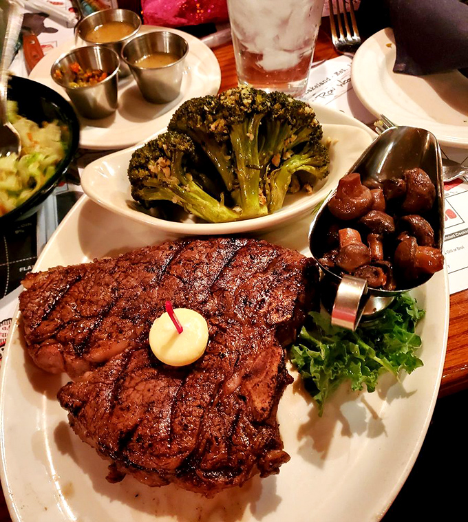 A steak that means business. The perfect char marks, a dollop of butter slowly melting, and sides that don't apologize for being delicious.