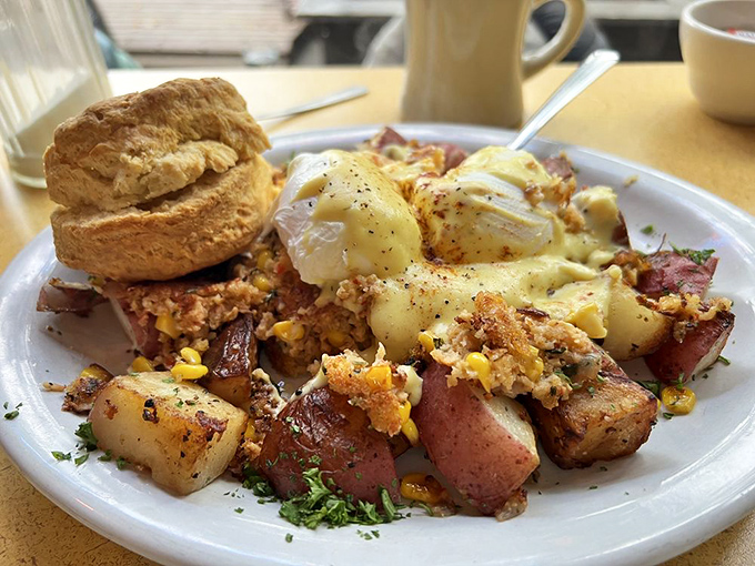 Breakfast alchemy at its finest&mdash;poached eggs crowning a mountain of savory hash with a biscuit standing guard. This plate doesn't just feed you; it hugs you.