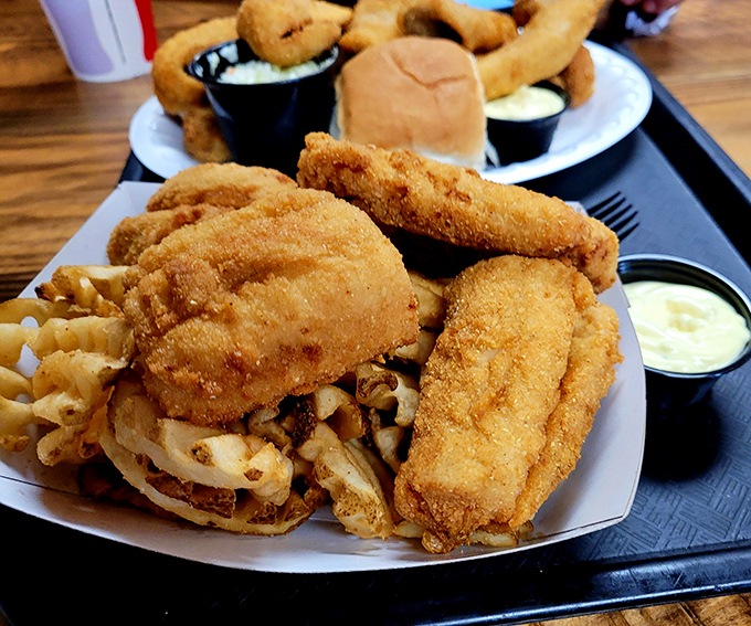 Golden-fried perfection that would make Neptune himself weep with joy. The holy trinity of fish, fries, and tartar sauce elevated to art form.