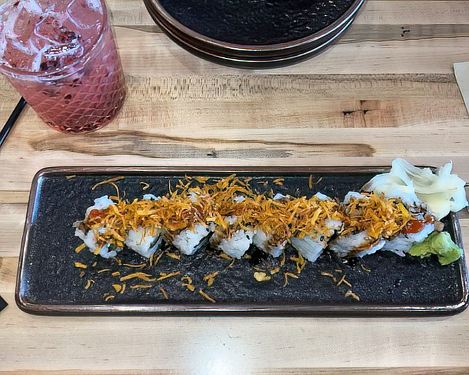 Sushi that dresses to impress! These rolls come topped with crispy garnish&mdash;like they're wearing tiny, delicious party hats.