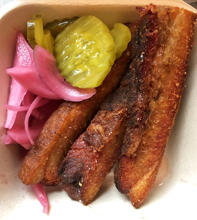 Pork belly perfection with pickles that pop. These glistening meat strips have the ideal fat-to-meat ratio that barbecue dreams are made of.