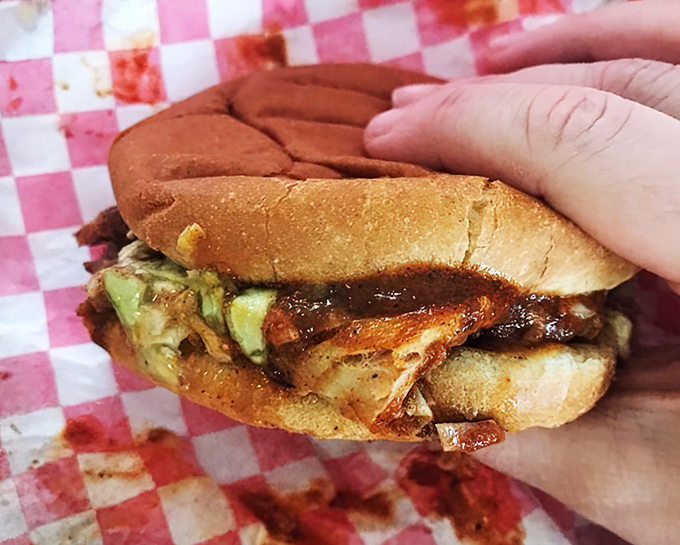 This isn't just a sandwich&mdash;it's edible architecture where smoke-kissed pork and tangy slaw create the perfect bite.