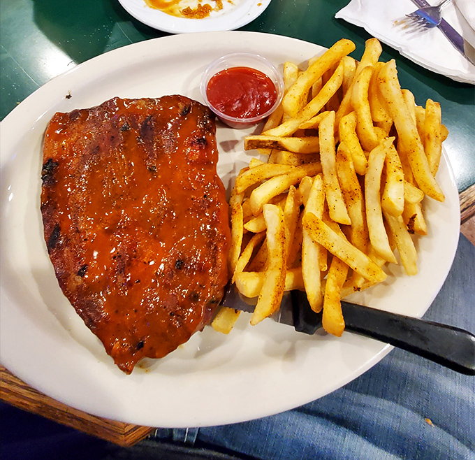 This pork steak isn't just dinner&mdash;it's a commitment to excellence with a side of perfectly seasoned fries standing at attention.