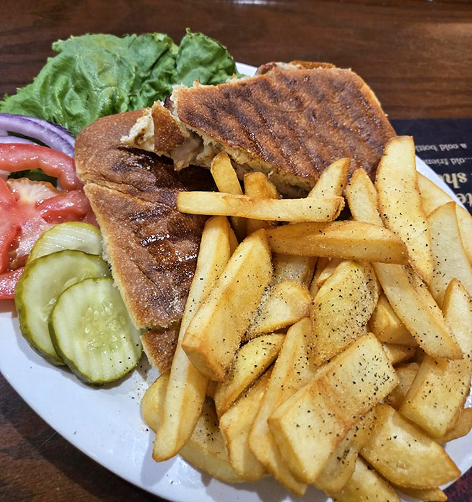 A proper Midwest pork tenderloin doesn't hide behind fancy garnishes—it demands most of the plate and makes the fries fight for space.