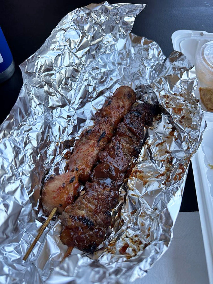 These glistening pork BBQ skewers aren't just food; they're edible love letters from the Philippines, wrapped in caramelized marinade.