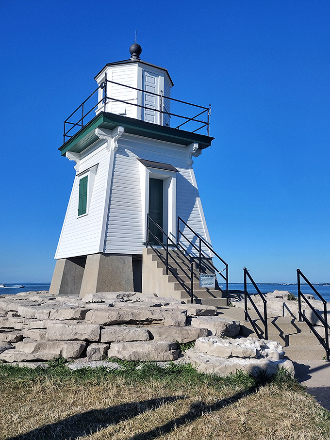 This postcard-perfect lighthouse isn't compensating for anything – it's exactly the right size for guiding both ships and retirement dreams safely to shore.