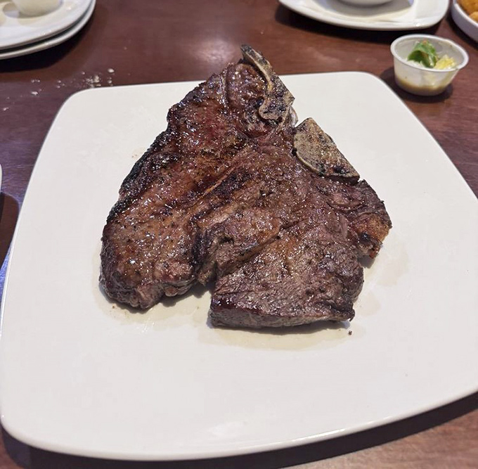 Behold the legendary Porterhouse – a monument to beef that makes vegetarians question their life choices from across the room.