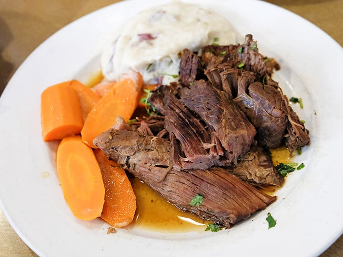 Behold the pot roast that launched a thousand food pilgrimages. Fork-tender beef that practically surrenders before you even pick up your knife.
