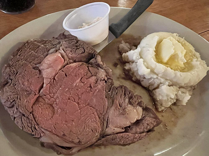 The weekend star attraction: perfectly cooked prime rib with a crater of melted butter crowning those cloud-like mashed potatoes. Carnivore poetry on a plate.