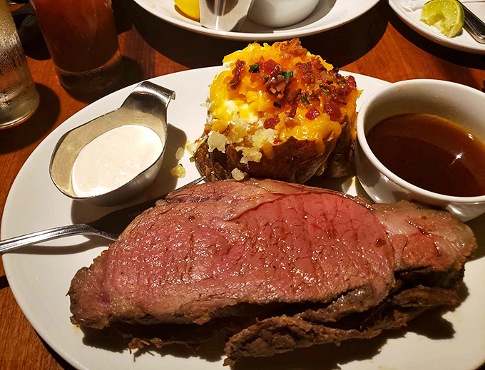 Behold the star of the show: prime rib so perfectly pink it makes you want to write poetry, paired with a loaded baked potato that's having its own moment. 