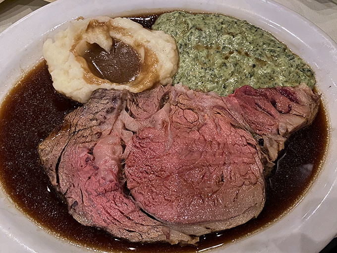 This isn't just prime rib; it's a masterclass in meat. The rosy interior, seasoned crust, and pool of au jus create the holy trinity of steakhouse perfection.