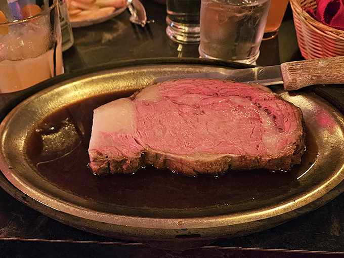 Behold the star of the show – prime rib so perfectly pink it should have its own Instagram account. This is meat meditation at its finest.