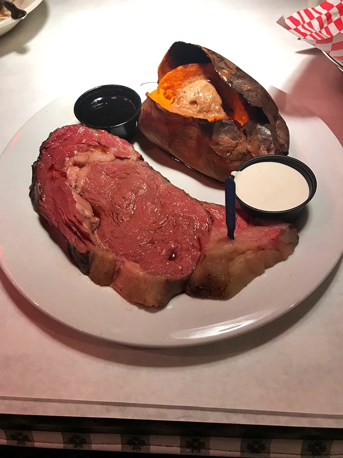 The star of the show arrives: prime rib so perfectly pink it should have its own Instagram account, accompanied by a loaded baked potato that's dressed for success.