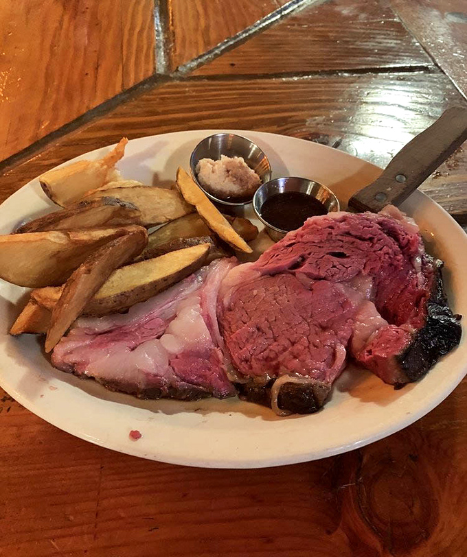 This prime rib arrives like a carnivore's dream&mdash;perfectly pink, accompanied by golden steak fries and those essential sides of jus and horseradish.