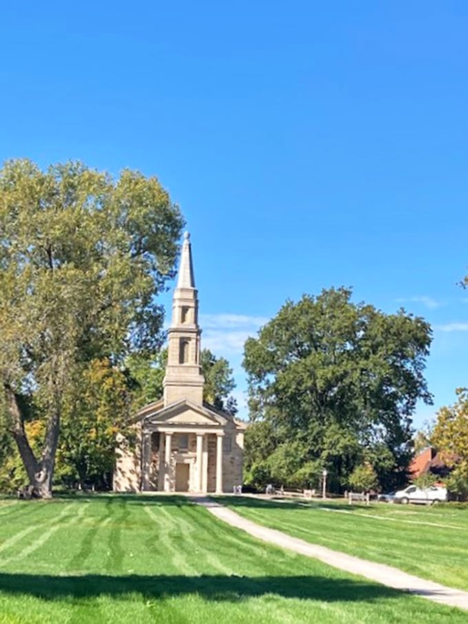 This stately limestone church stands as a testament to craftsmanship that's outlasted empires, with a spire that's been guiding travelers home for over a century.