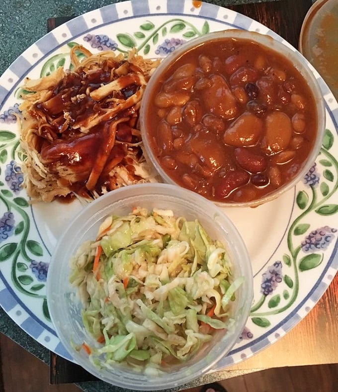 A holy trinity of barbecue goodness&mdash;pulled chicken bathed in sauce, hearty baked beans, and coleslaw that adds just the right crunch to cut through the richness.