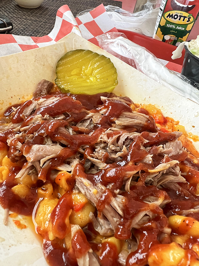 Pulled pork piled high atop mac and cheese with a pickle sentinel standing guard&mdash;a combination that makes taste buds stand at attention.