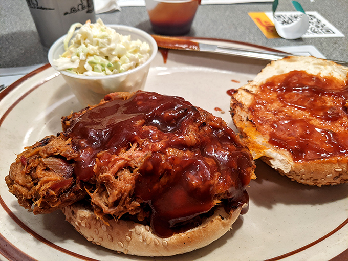 The pulled pork sandwich that launched a thousand road trips, glistening with sauce and practically begging you to ignore your napkin.