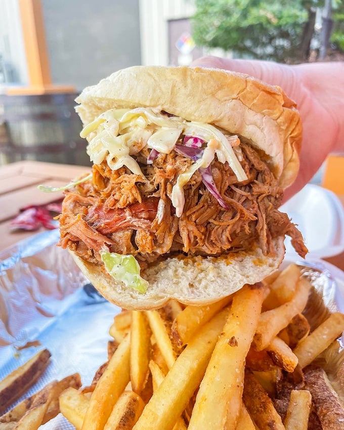 This pulled pork sandwich isn't just a meal&mdash;it's an architectural marvel of tender meat, crunchy slaw, and a bun that somehow contains the delicious chaos.