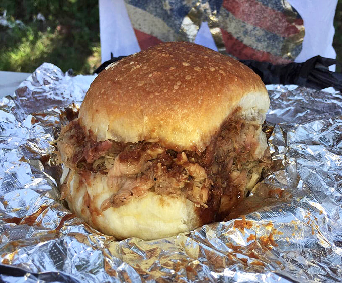 This isn't just a sandwich; it's a monument to patience. Tender pulled pork spilling out of a soft bun&mdash;the kind of meal worth driving across state lines for.